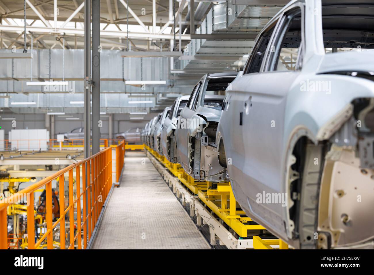 Photo of car bodies on assembly line. Factory for production of autos ...
