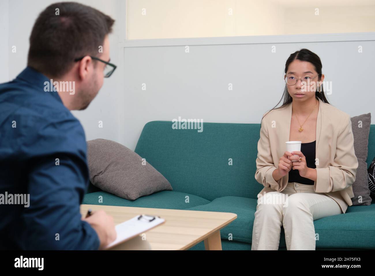 Caucasian male psychologist and asian woman patient at therapy Stock ...