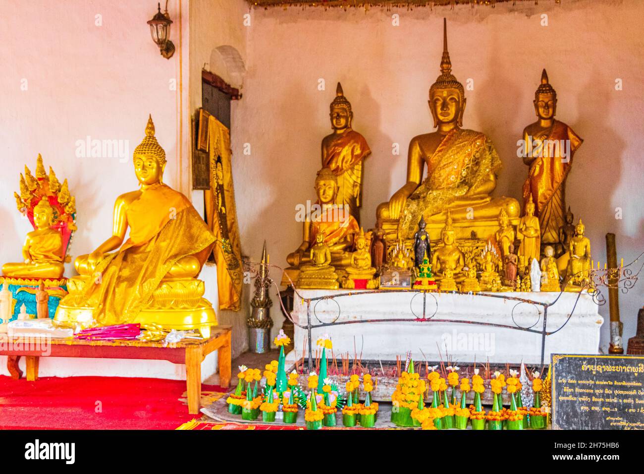 Golden buddha statues figures on the mountain Phousi Hill and Wat Chom ...