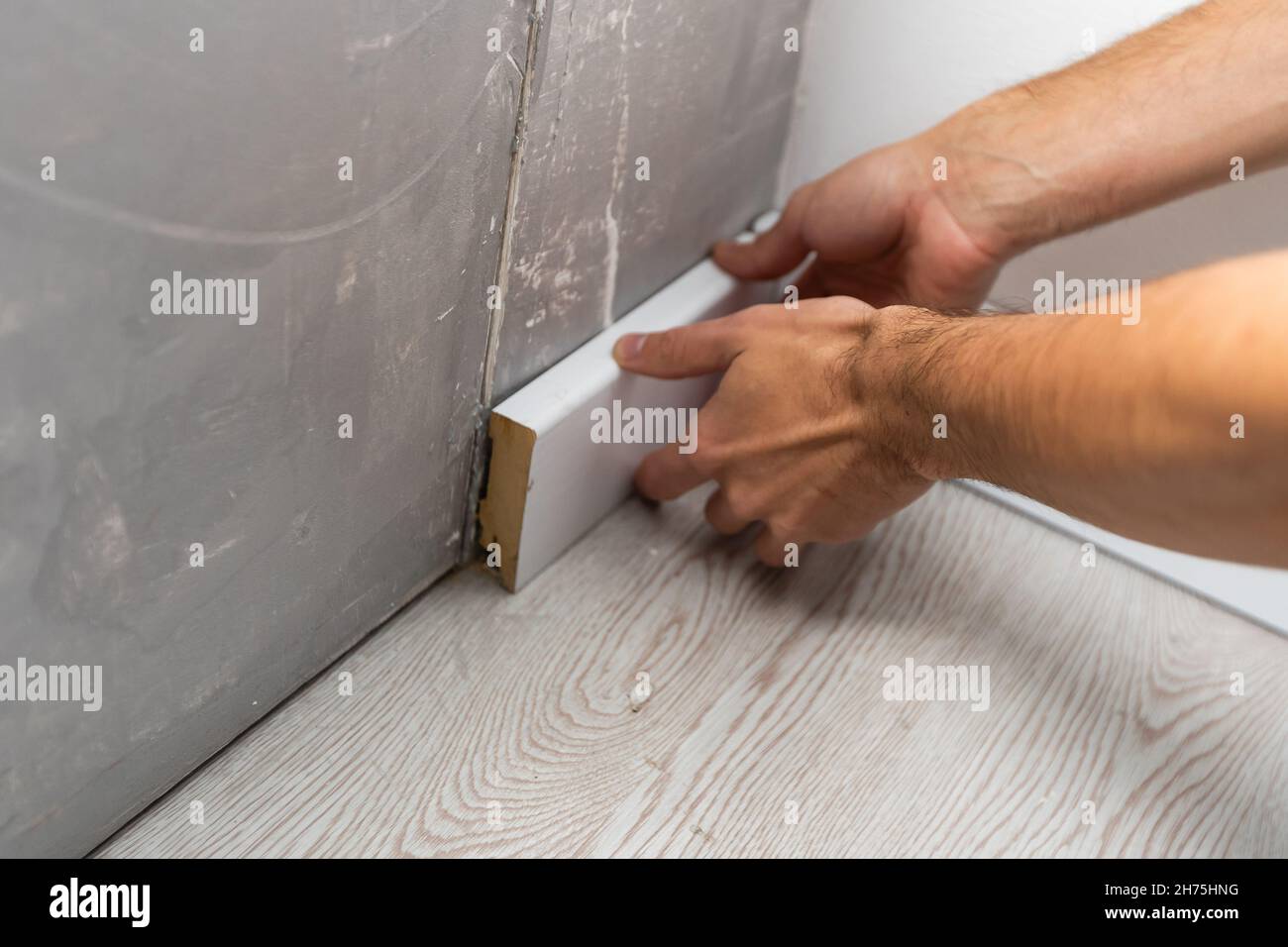 Installing the new skirting board after changing the parquet Stock ...