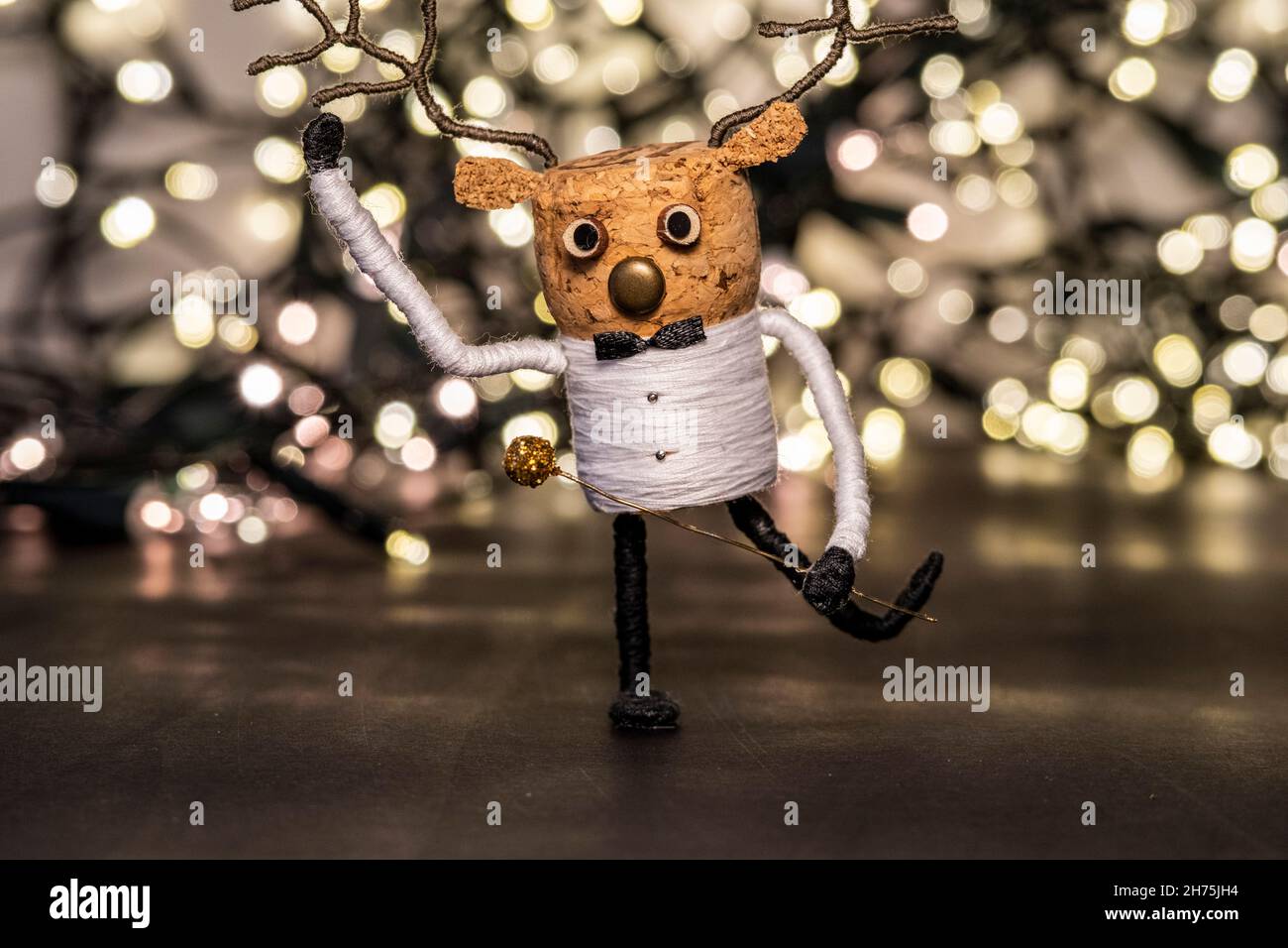 Christmas composition, dancing cork deer with Christmas lights ...