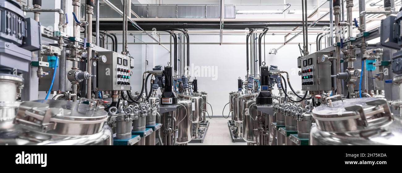 Panoramic photo of gray metal pipes and tanks. Chemistry and medicine ...