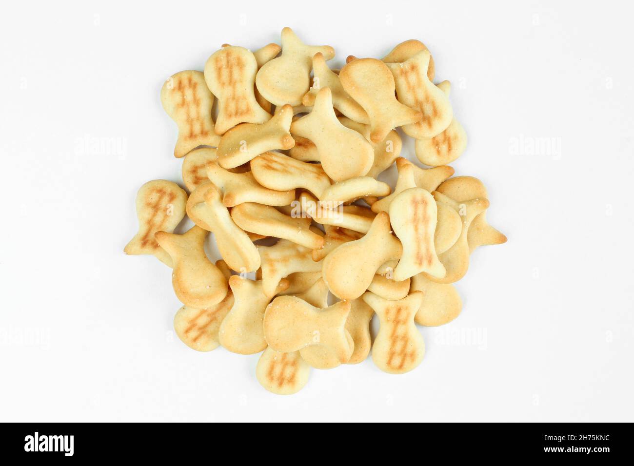 Pile of salty crackers isolated on white background. Fish shaped snack ...