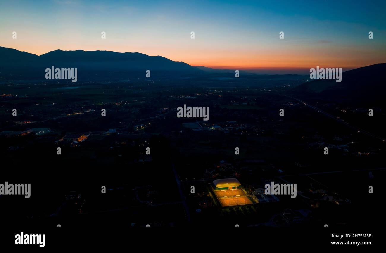 View from above, stunning aerial view of an illuminated tennis court ...
