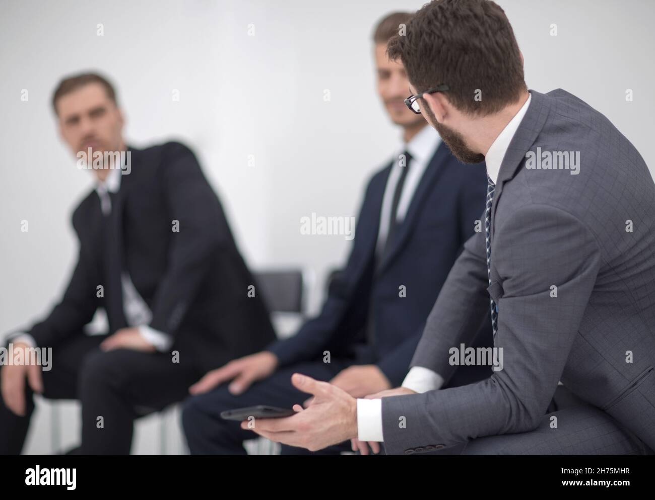 business colleagues sitting in office waiting room Stock Photo - Alamy