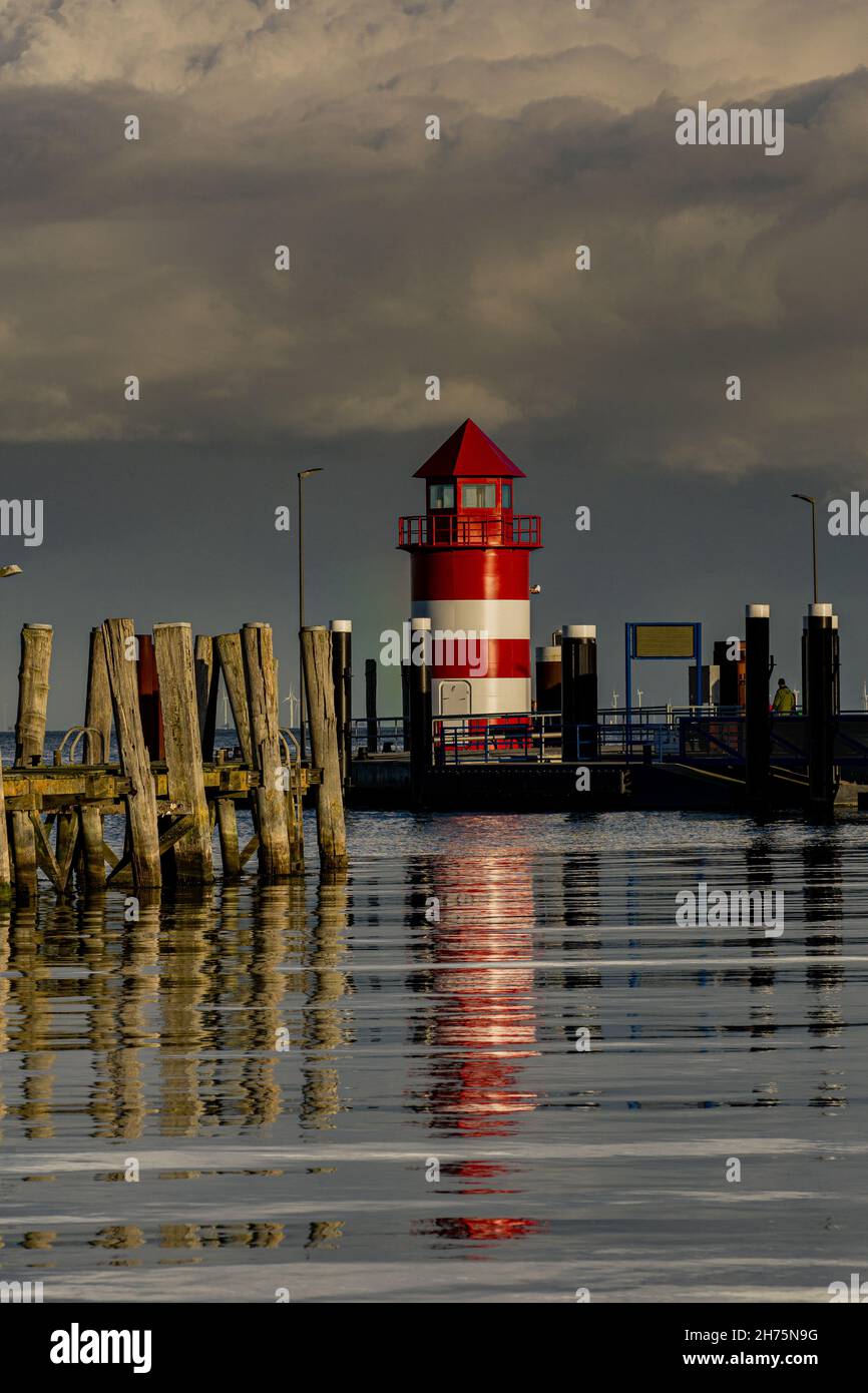Vertical shot of a lighthouse and its reflection in the sea Stock Photo ...