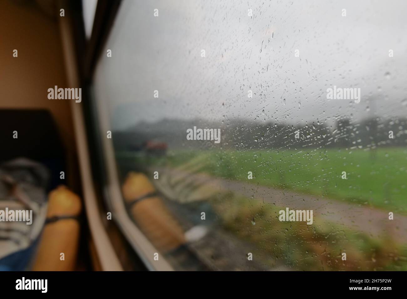 View of a rainy day through the window of the train Stock Photo - Alamy