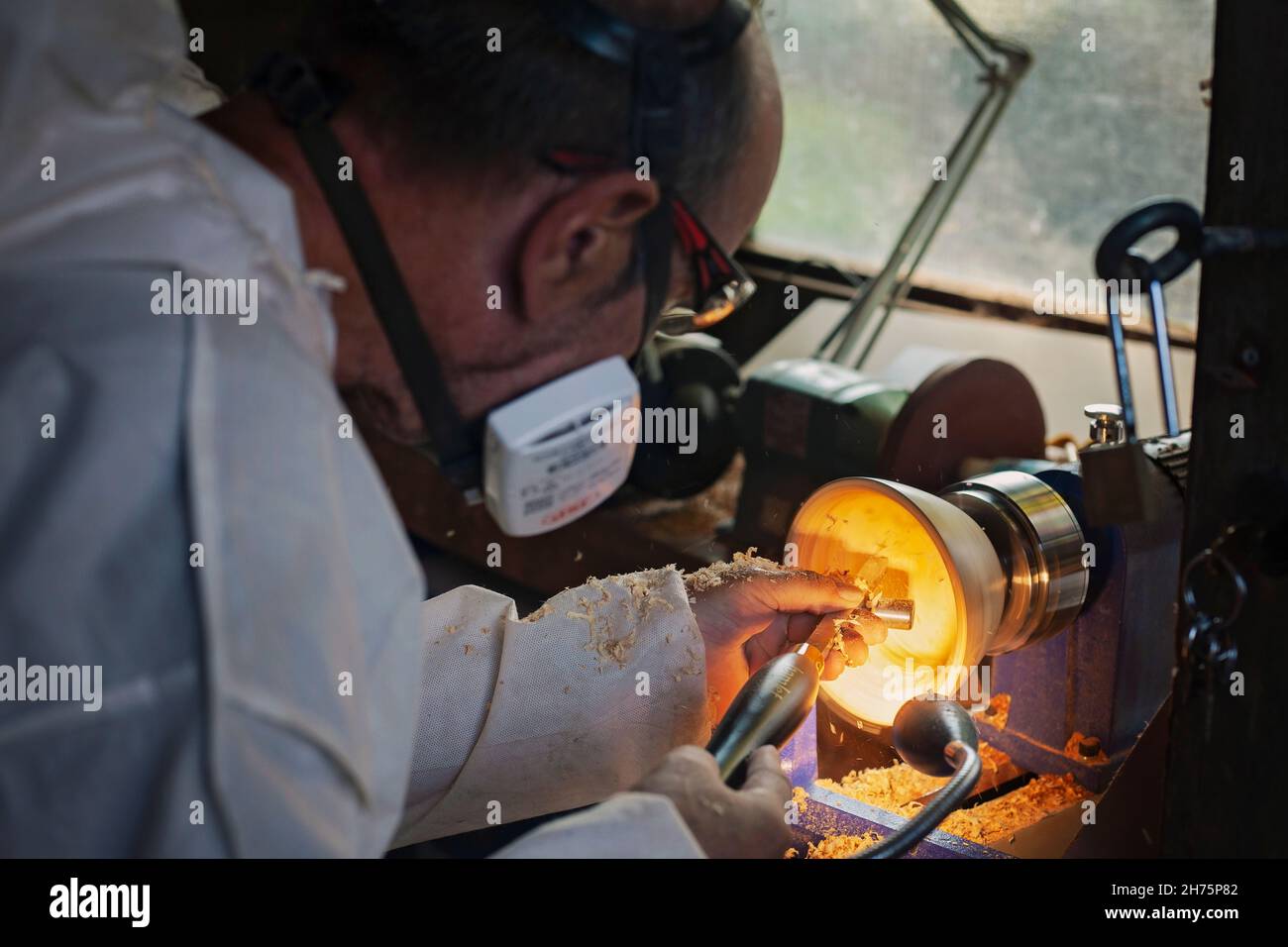 Man using a woodturning lathe to make a wooden bowl Stock Photo - Alamy