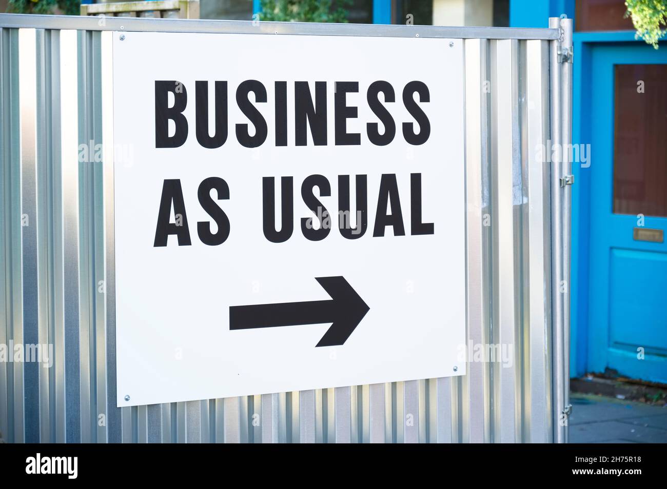 Business as usual open sign with direction arrow Stock Photo - Alamy