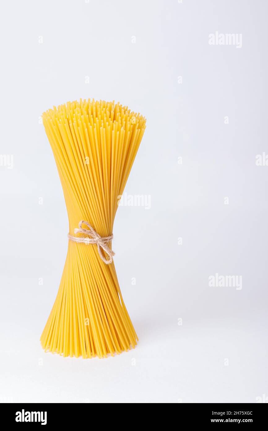 An upright bunch, a bunch of raw spaghetti tied with rope. Bundle on a ...
