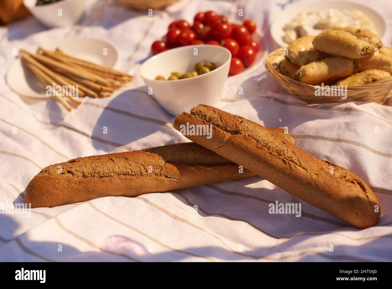 summer sunny picnic with bread, french baguette, olives, Cherry ...