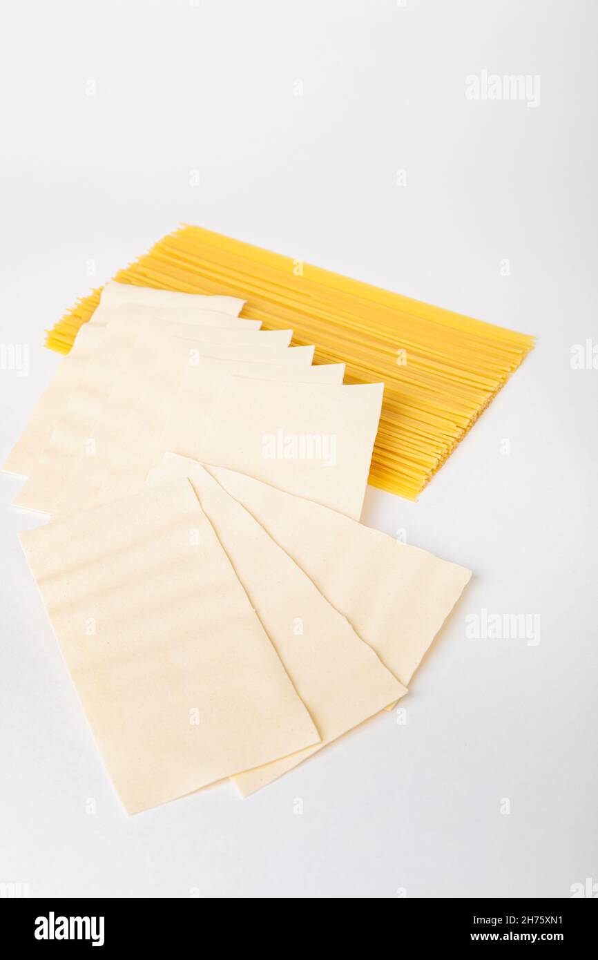 Raw lasagna. Dry dough sheets for lasagna on a white background ...