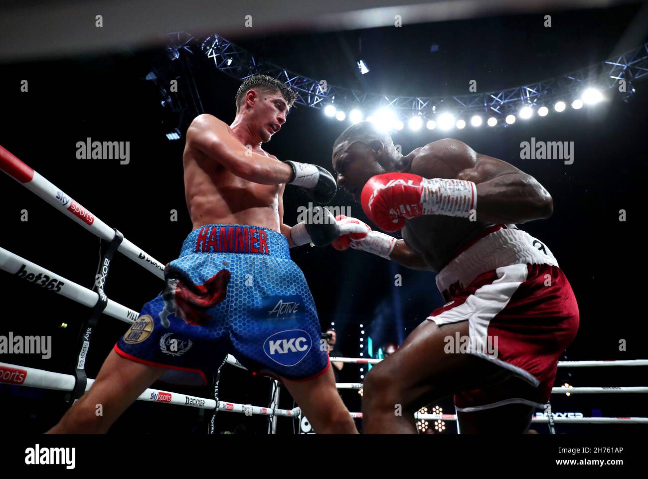 Hosea Burton (left) in action against Dan Azeez in the British Light Heavyweight Title fight ...