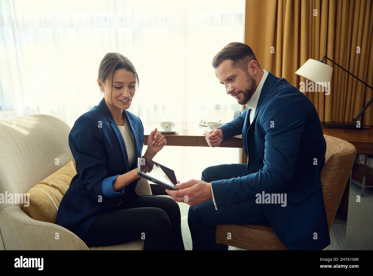 Young confident business woman presenting a project on a digital tablet ...