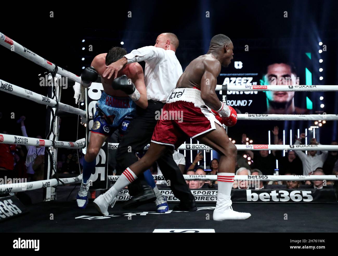 The referee steps in to end the British Light Heavyweight Title fight between Dan Azeez (right ...