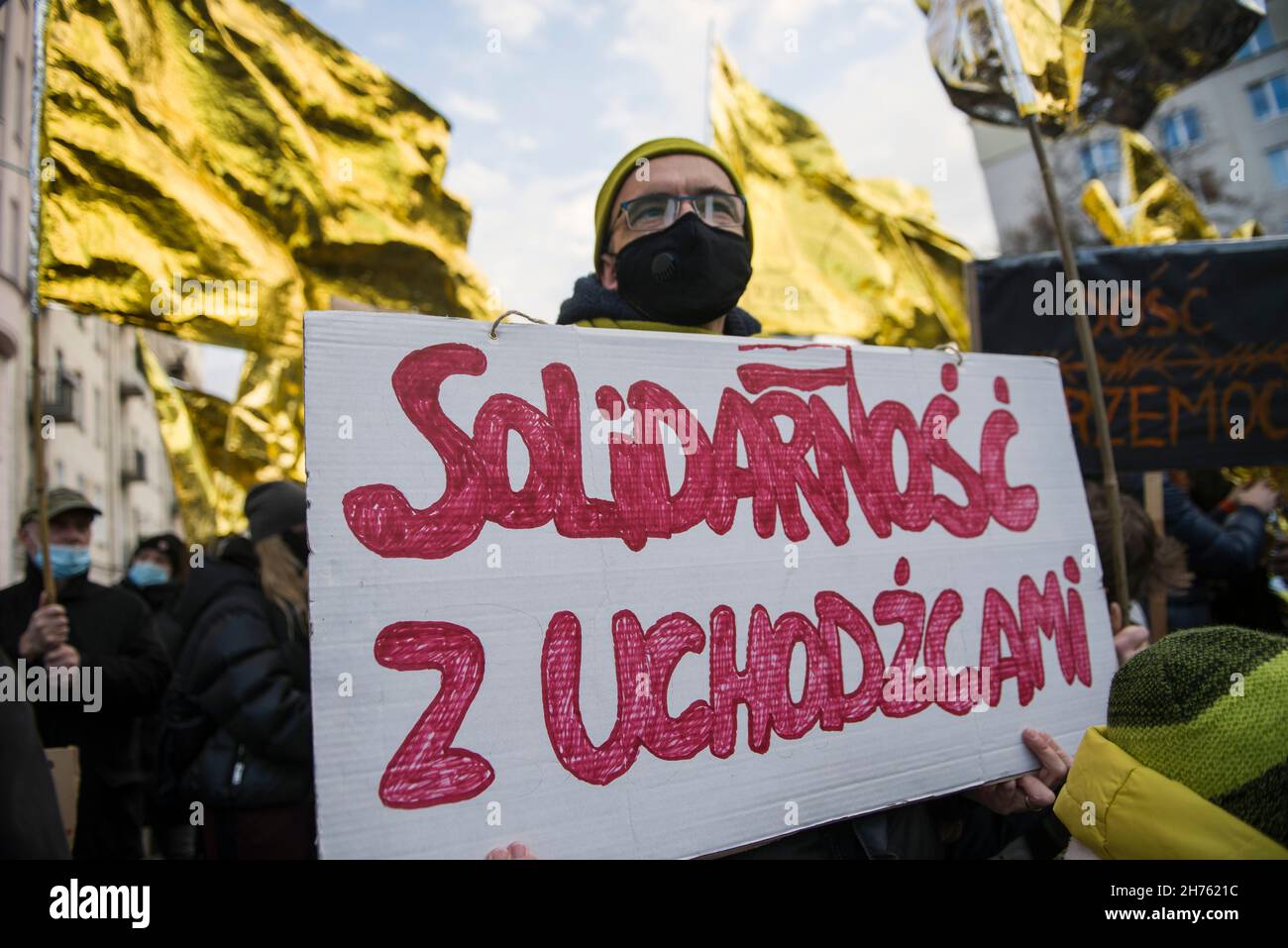 A protesters hold a placard that reads Solidarity with refugees, during ...