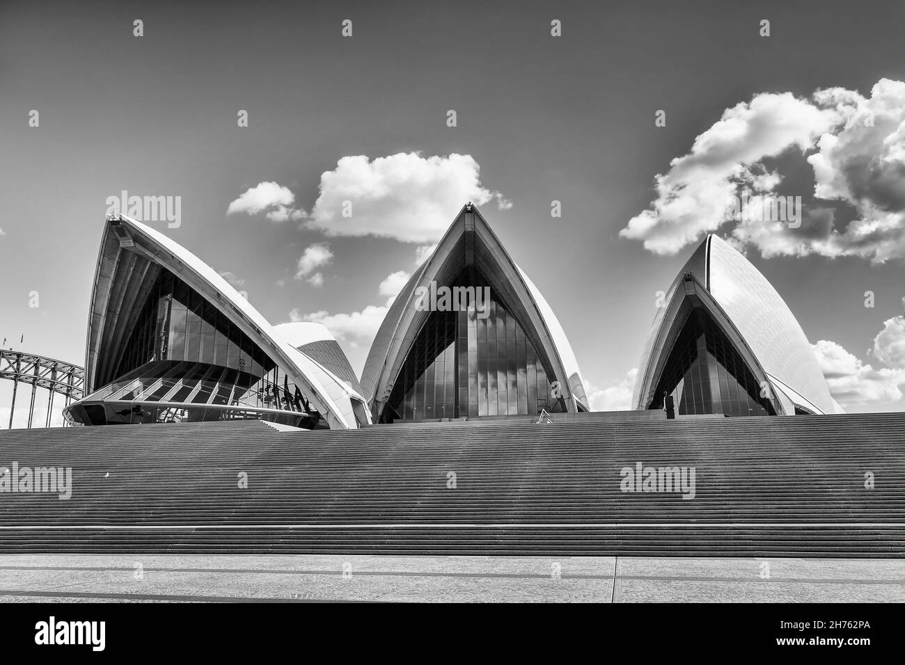 Dramatic contrast clouds reflecting in glossy glass windows of modern ...