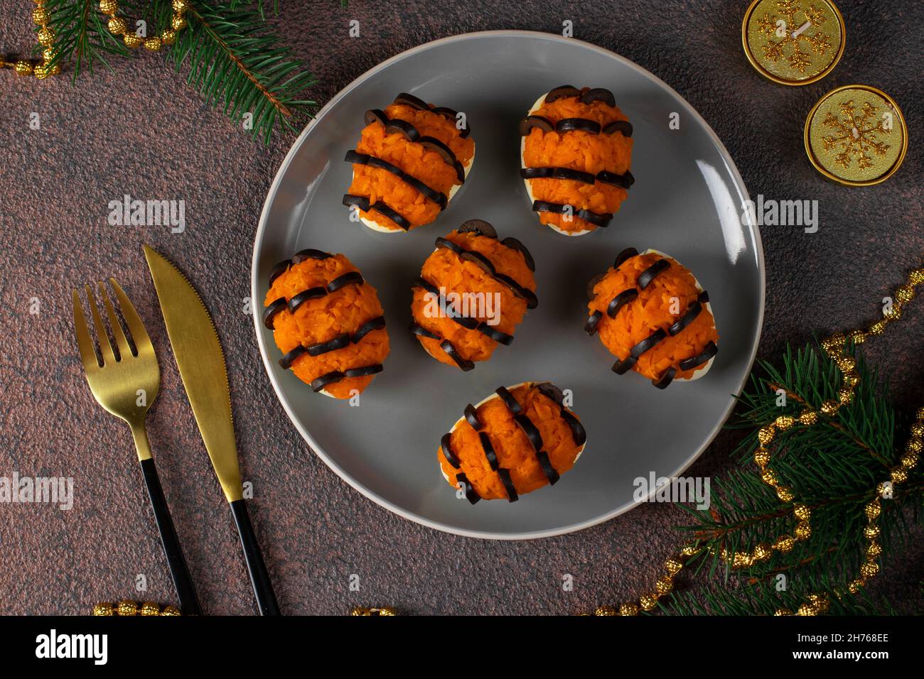 Tiger appetizer made of stuffed eggs with cod liver and carrot for New ...
