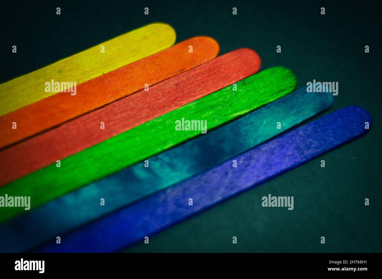 Colorful rainbow wooden sticks on a surface Stock Photo - Alamy