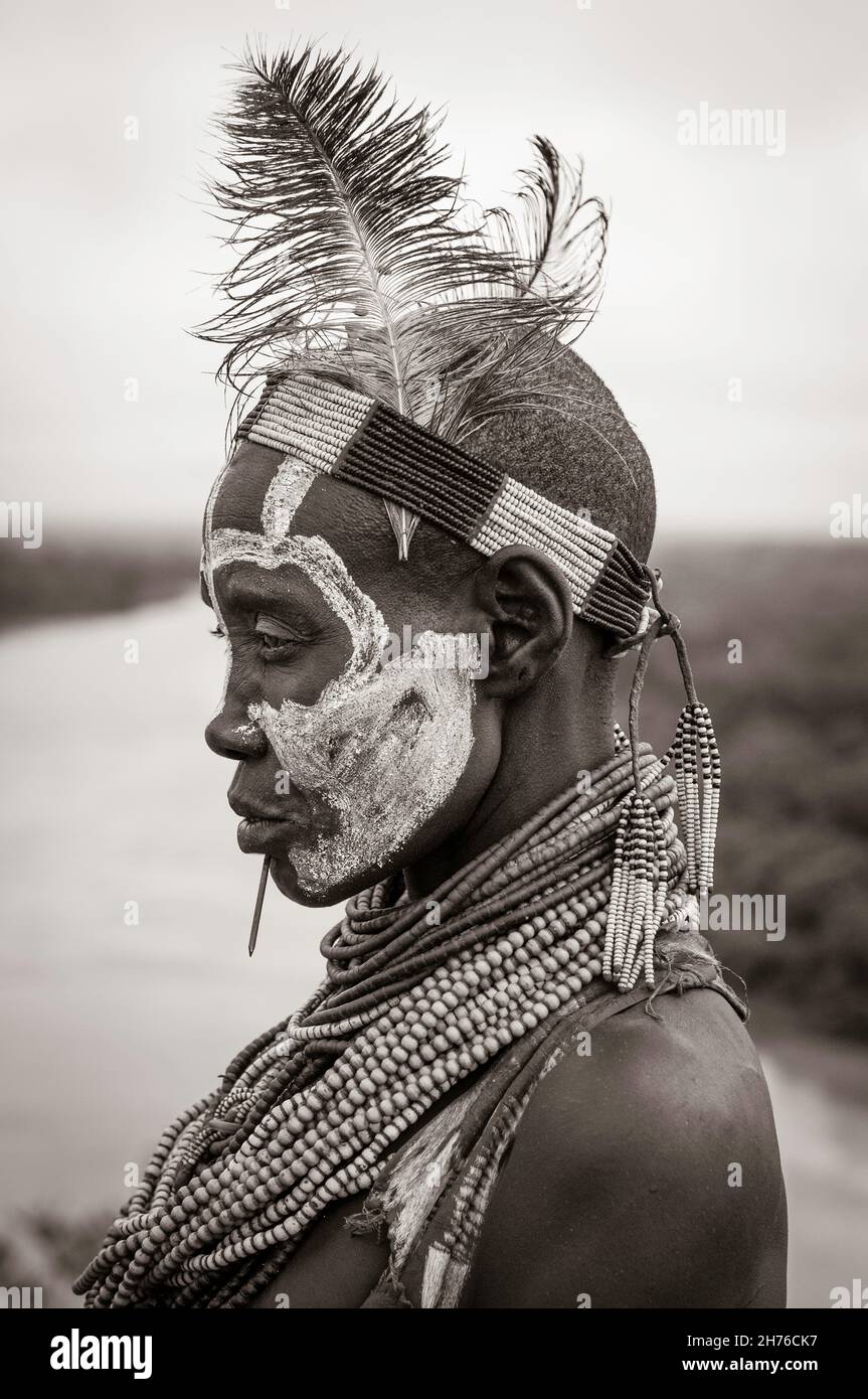woman from the Karo Tribe with a painted face and feather for ...