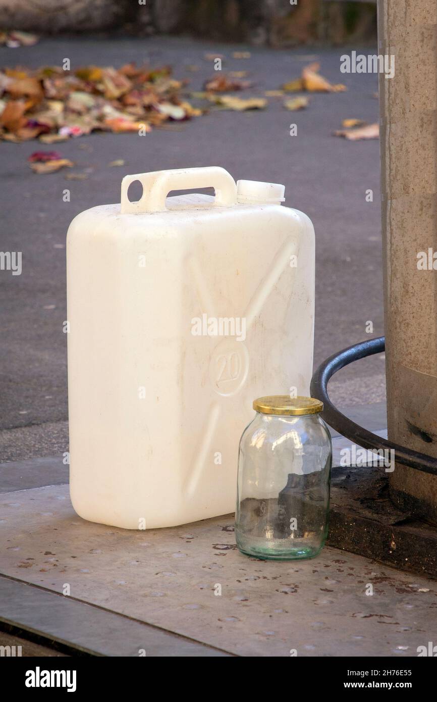 Empty plastic jug bottle outside on a street ready to be filled with ...