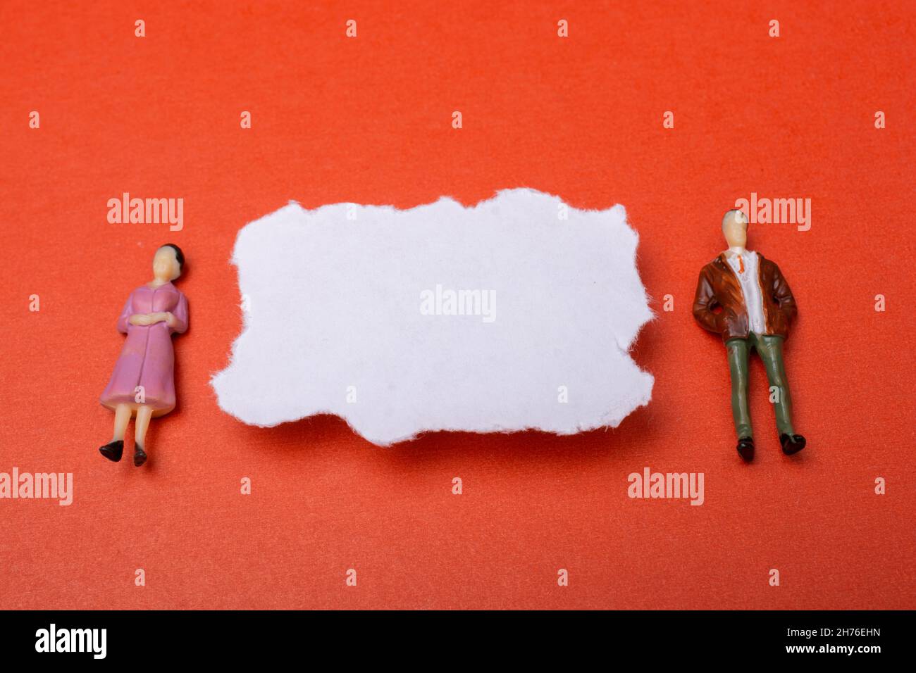 human figurine beside white torn paper Stock Photo - Alamy