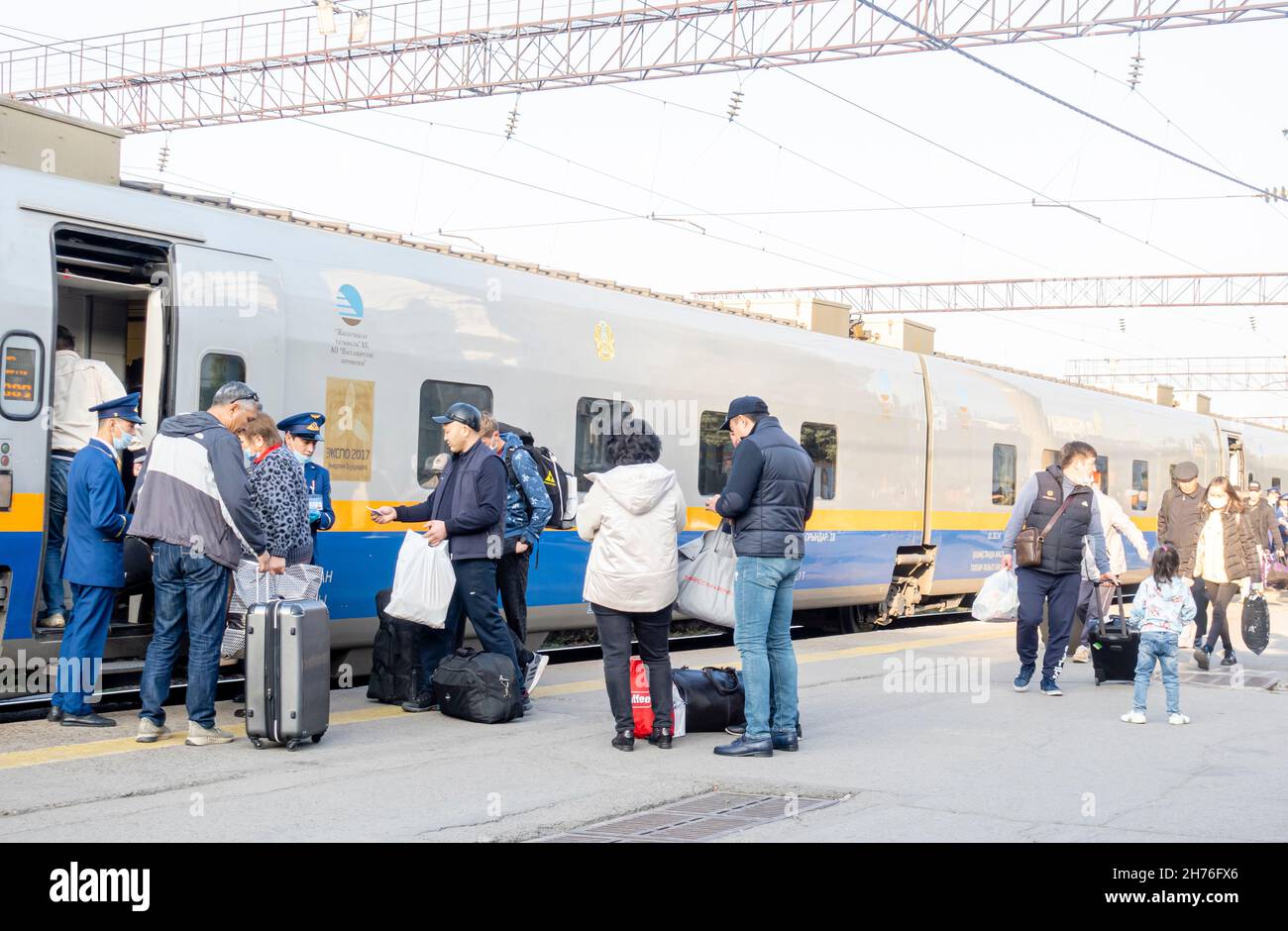 Passengers boarding, checking in on a train at a train stop. Kazakh ...