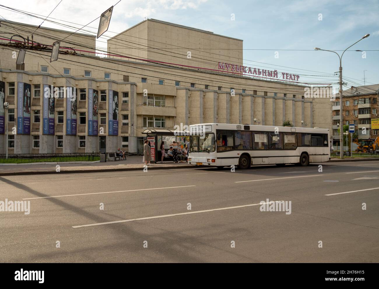 The bus stop of the same name with people in front of the building of ...