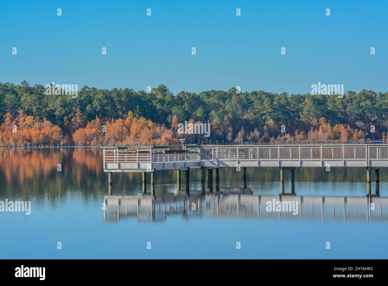 A reflection of the fishing pier and Fall leaf colors on Little ...