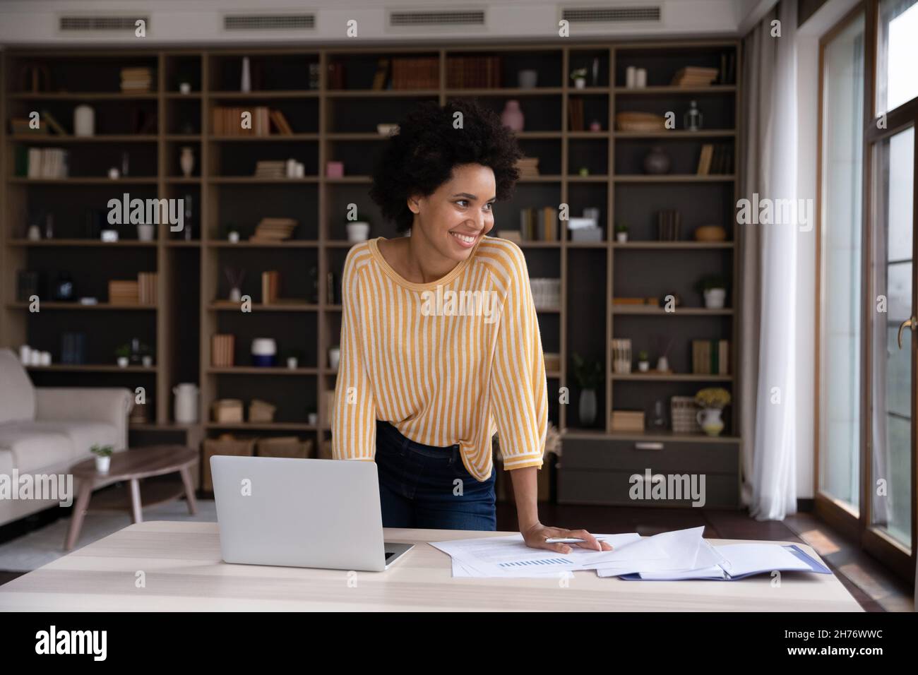 Happy Black millennial remote worker satisfied with job result Stock ...