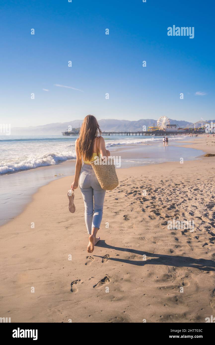 Woman walking towards sea ocean waves hi-res stock photography and ...