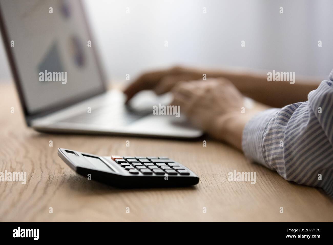 Close up focus on calculator, female hands on laptop keyboard Stock ...