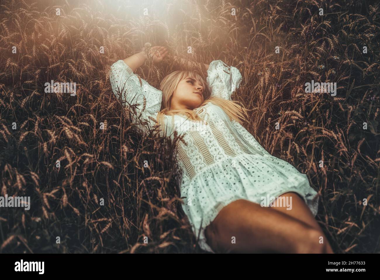 Beautiful woman in ornamental clothing in a wheat field Stock Photo - Alamy