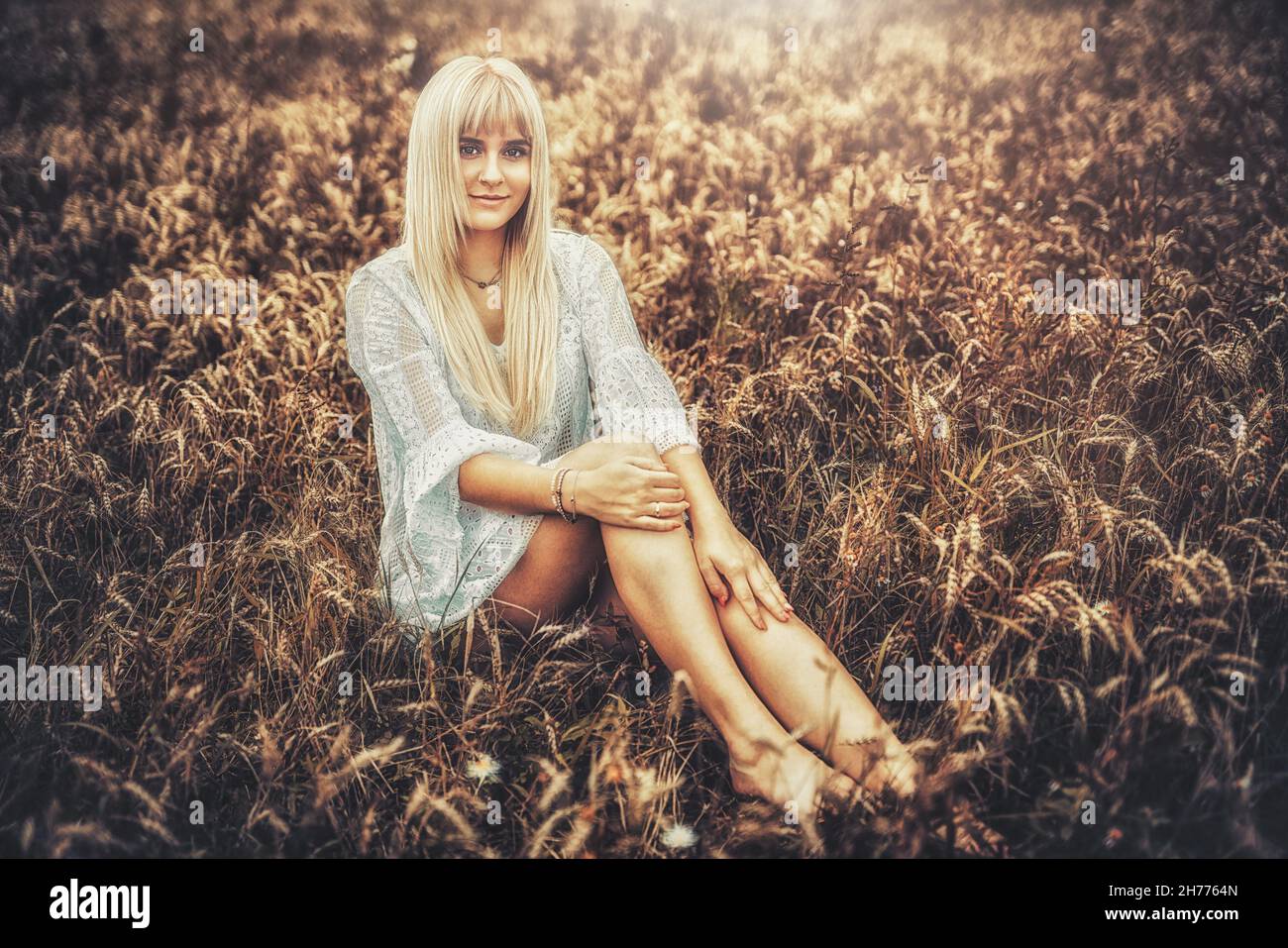 Beautiful woman in ornamental clothing in a wheat field Stock Photo - Alamy