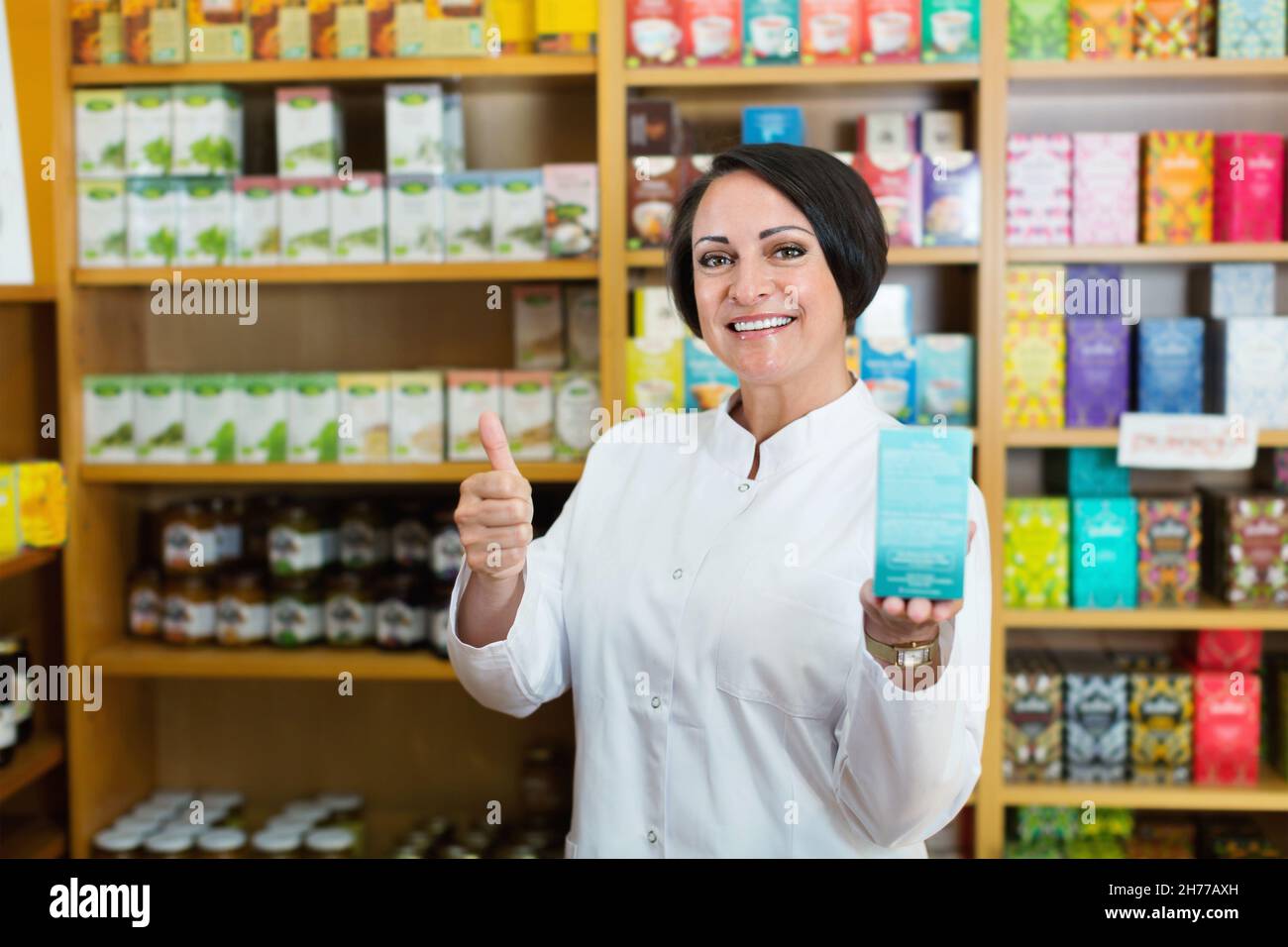 Woman in white coat promoting food additive goods in carton in ...