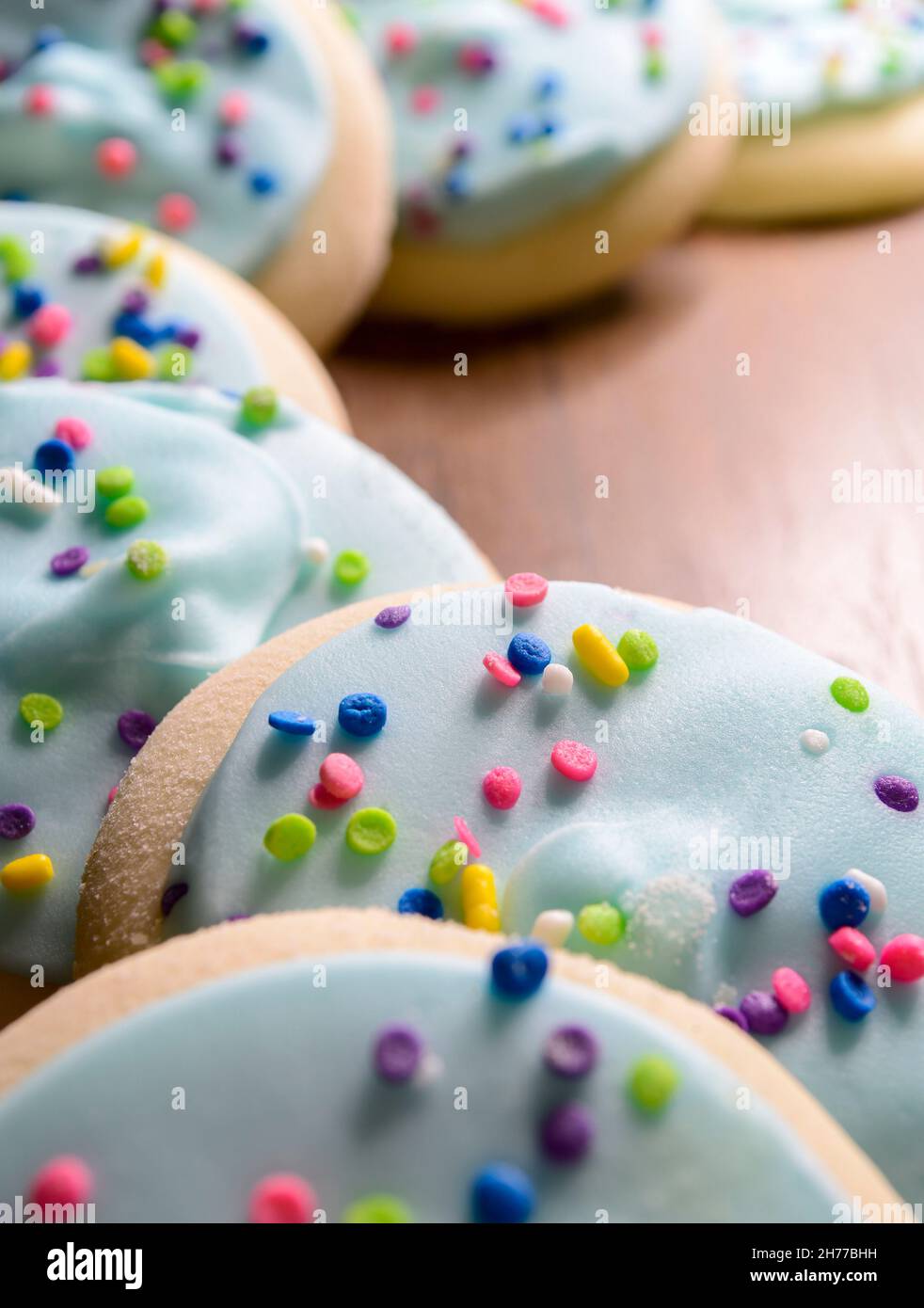 Sugar cookie with blue frosting and sprinkles Stock Photo - Alamy