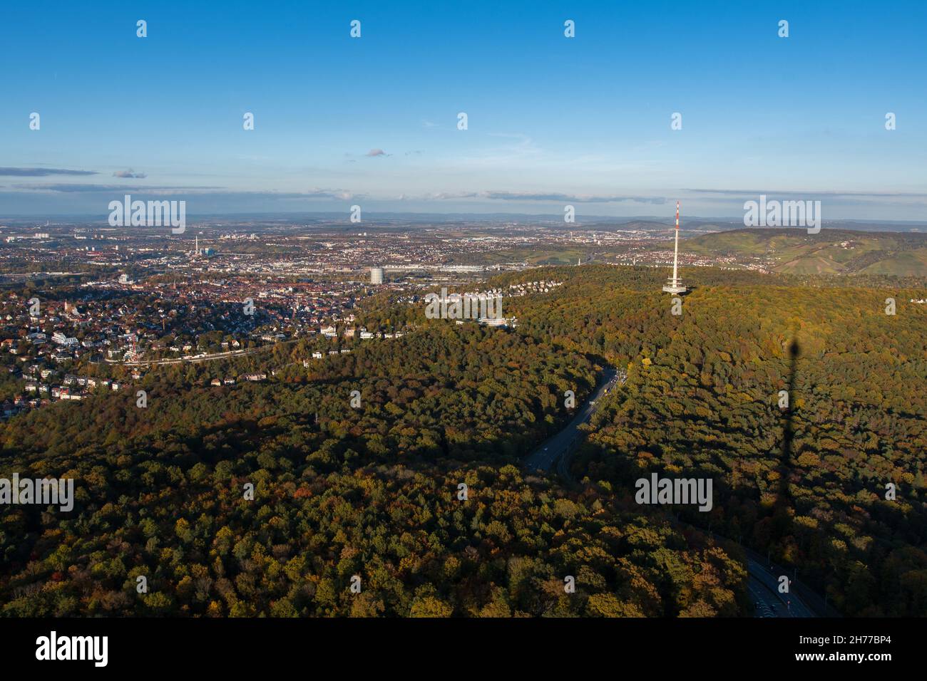 An aerial view of telecommunication tower surrounded by forest trees ...