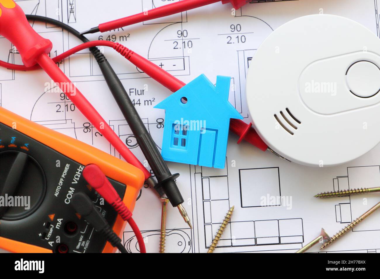 smoke detector with a screwdriver and a measuring device on a circuit ...