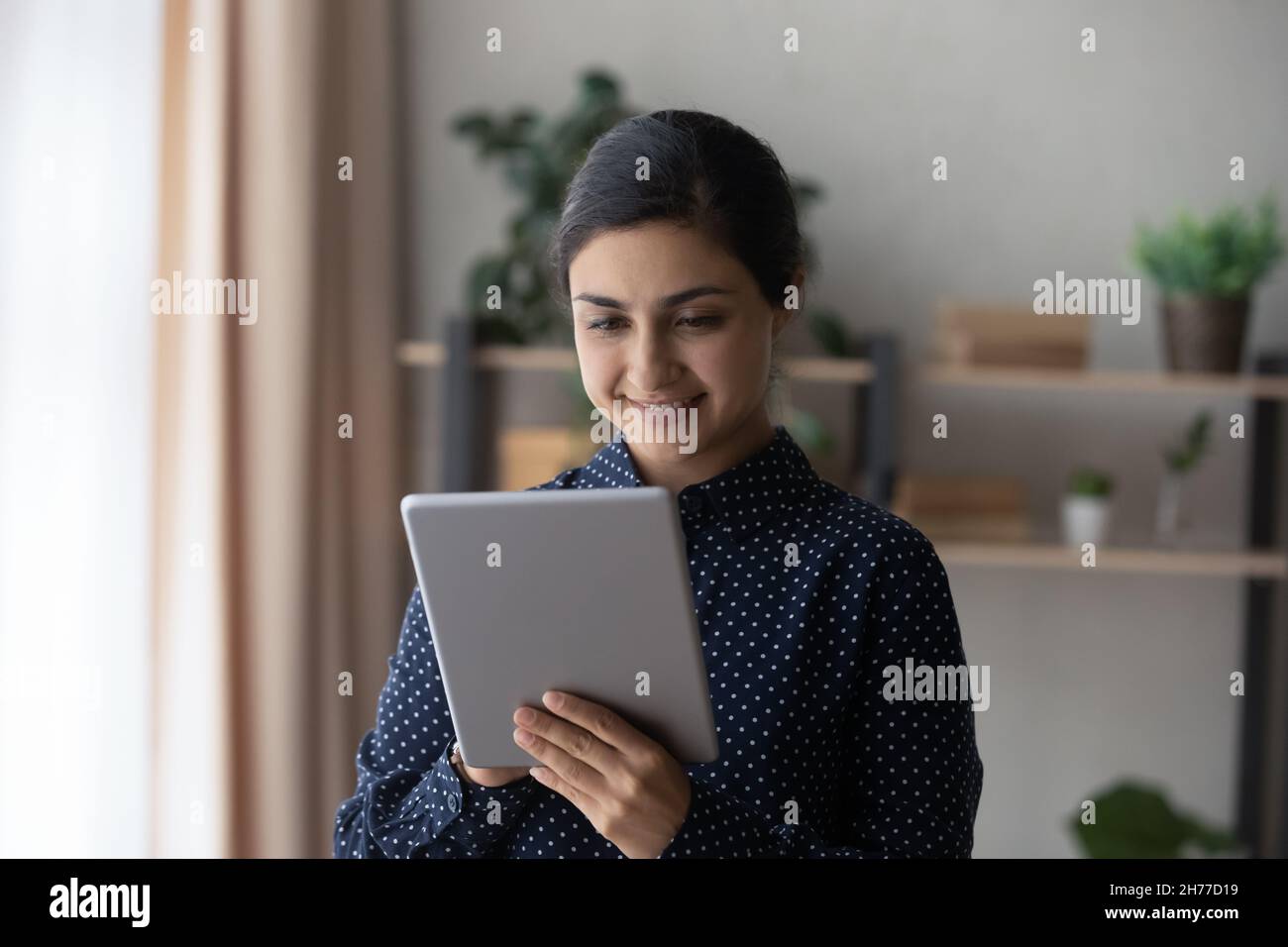 Happy millennial Indian woman using digital computer tablet Stock Photo ...