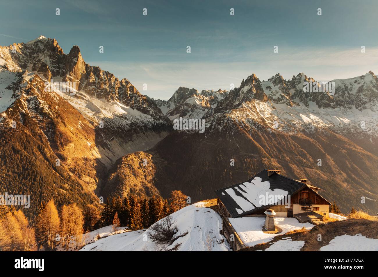 traditional french alpine chalet at the top of snowy mountain at sunset ...