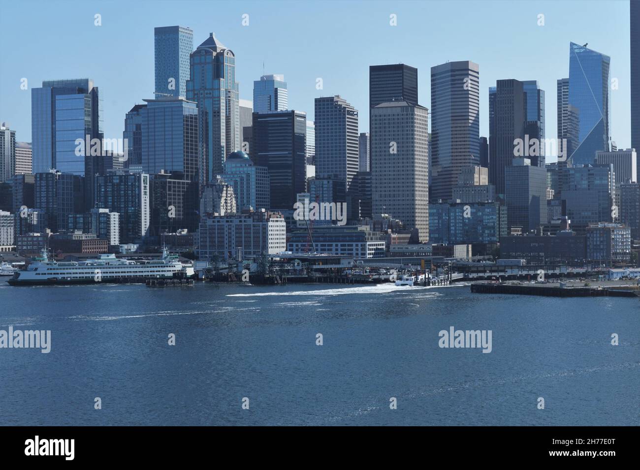 City skyline of Seattle and passenger ferry in port situated on Puget ...