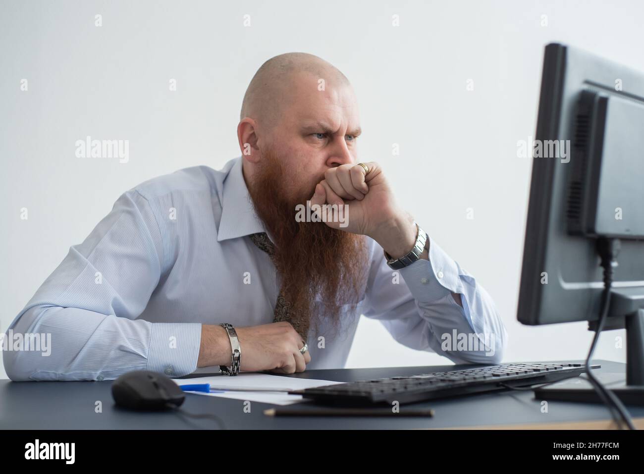 Problems for the office worker. A bald man in a white shirt sits at a ...