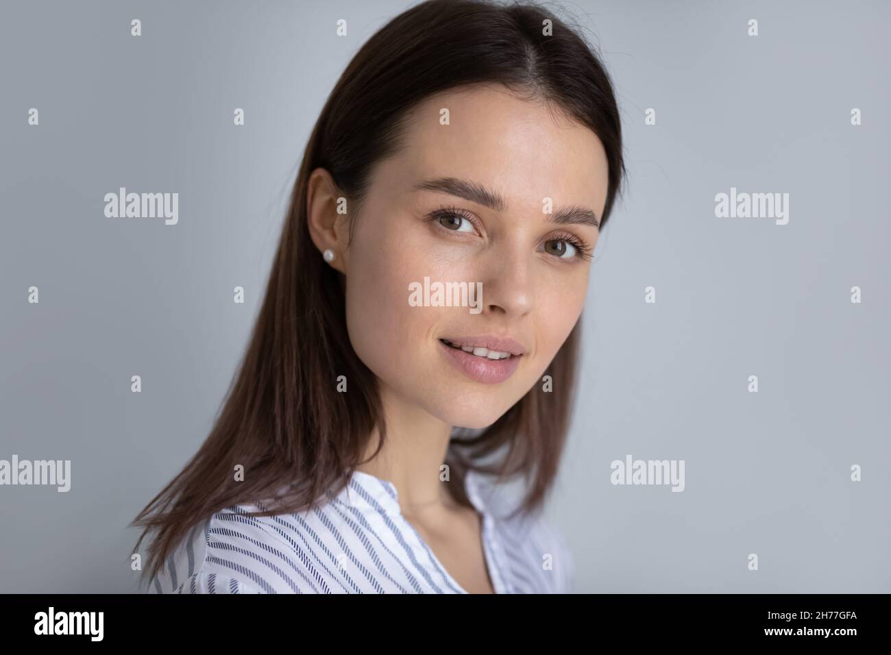 Attractive smiling millennial woman isolated on white studio background ...