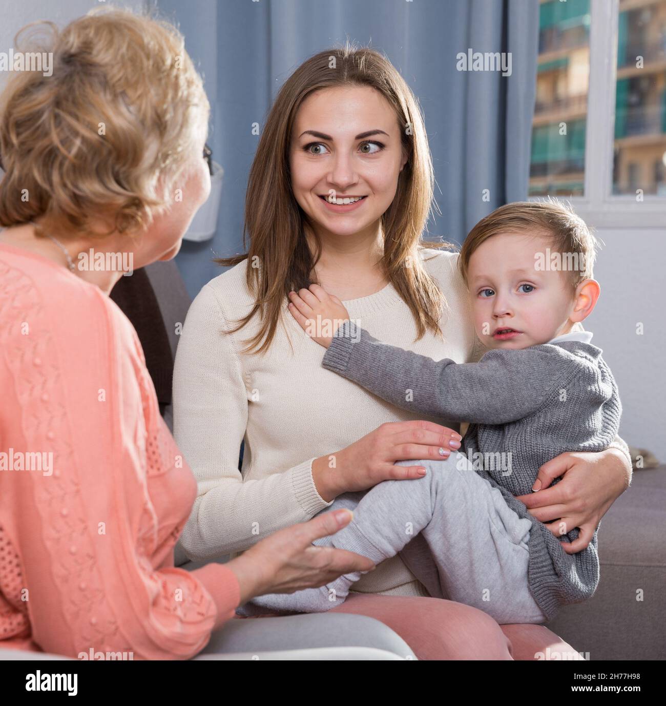 Two adult female are talking about upbringing kid Stock Photo - Alamy