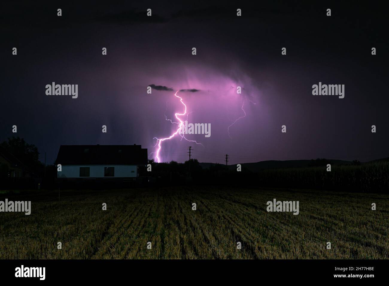 Lightning strikes behind a house in the countryside of Transylvania ...