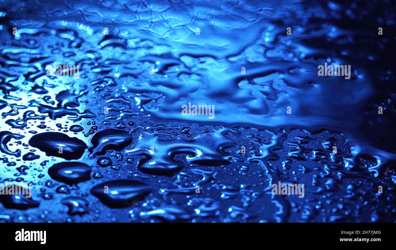 Shooting of rainy drops on dark blue background Stock Photo - Alamy