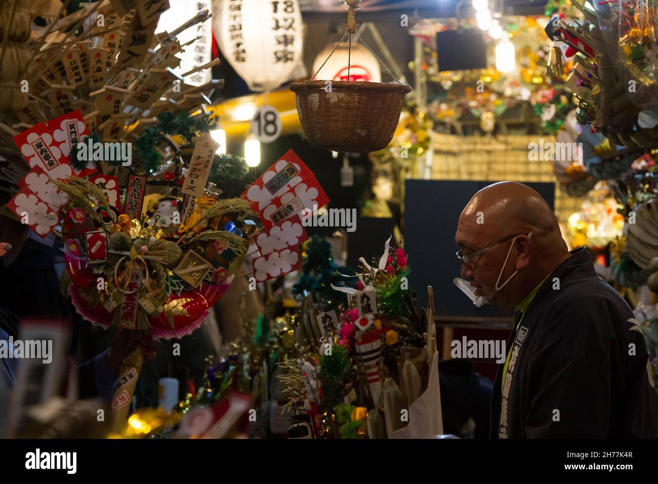 Kumade (rake) stall holder seen at the Tori no Ichi or Cock festival at ...