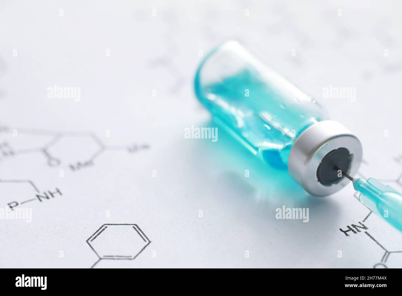 small jars with injection and syringe for injection on blue background ...