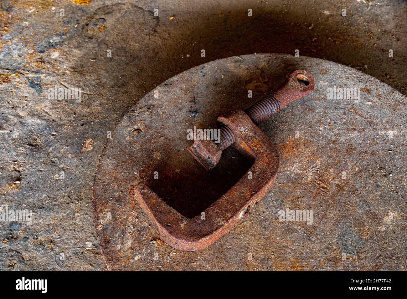 An antique work tool - hitch on a rusty surface Stock Photo - Alamy