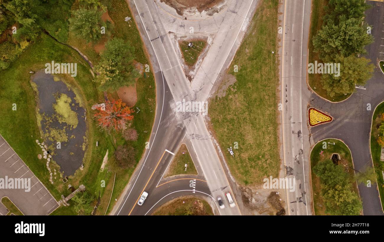 An aerial shot of roads surrounded by greenery in the daylight in ...